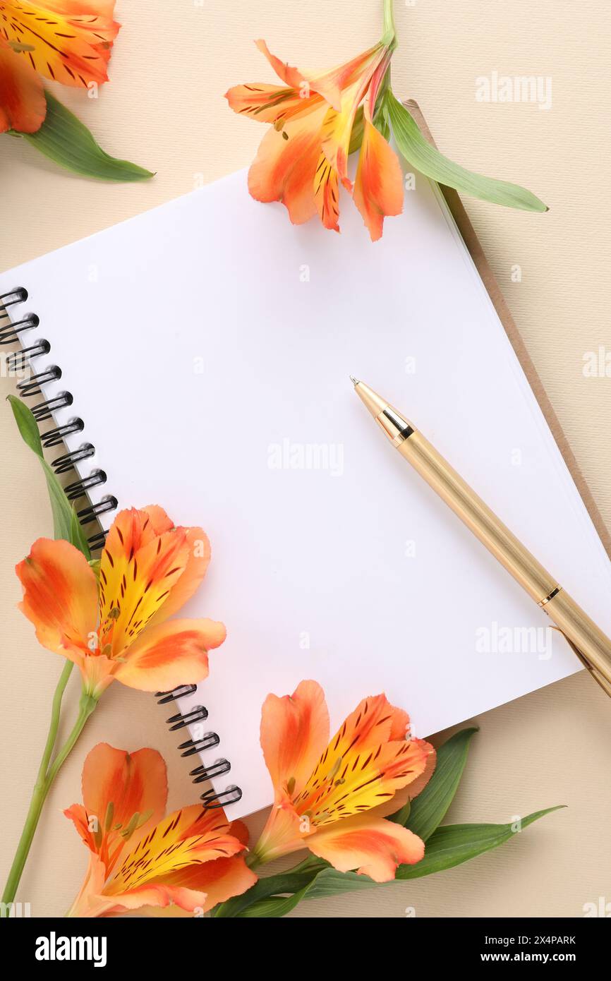 Guest list. Notebook, pen and beautiful flowers on beige background ...