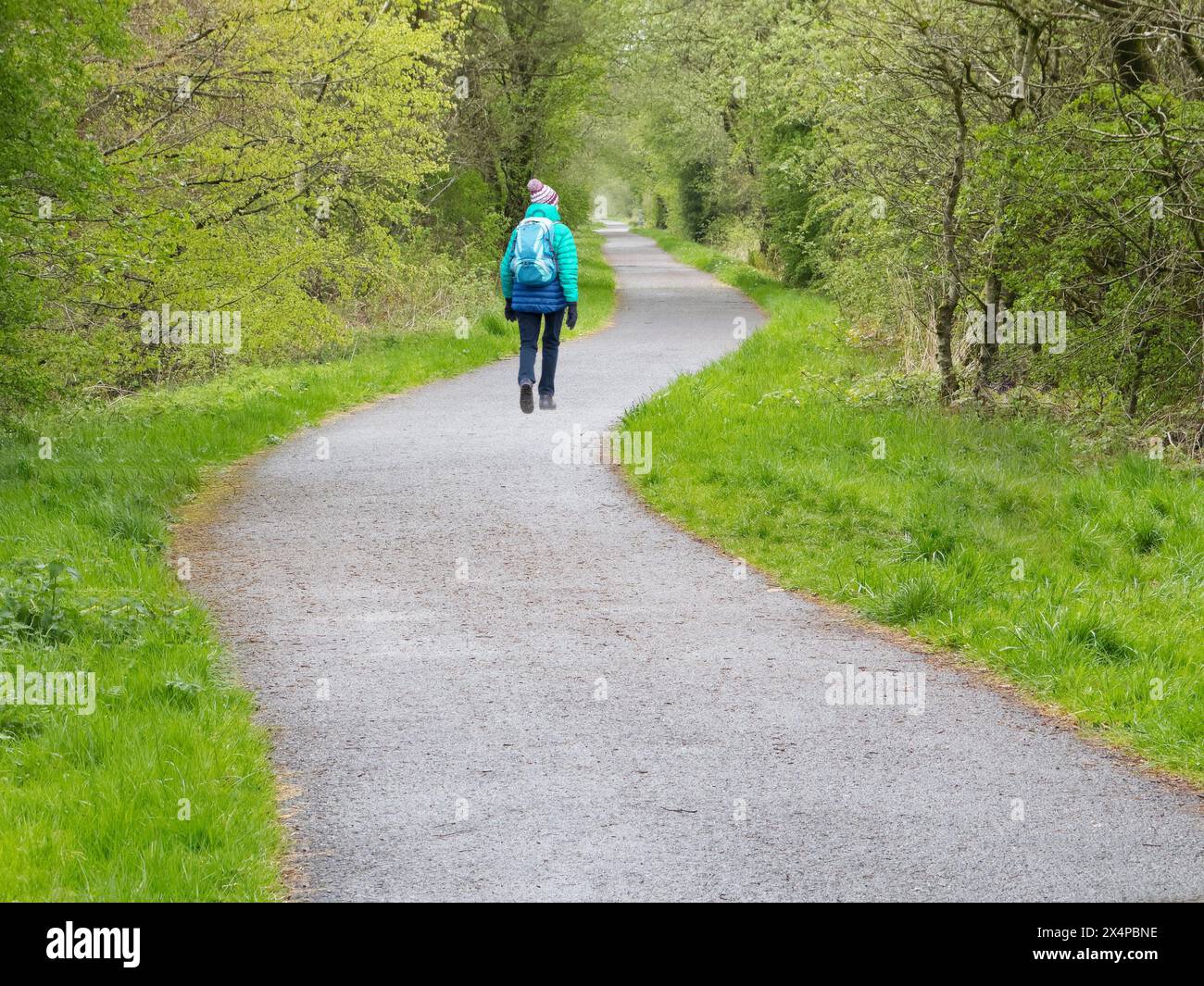 Elderly women walking alone on path in the countryside Stock Photo - Alamy