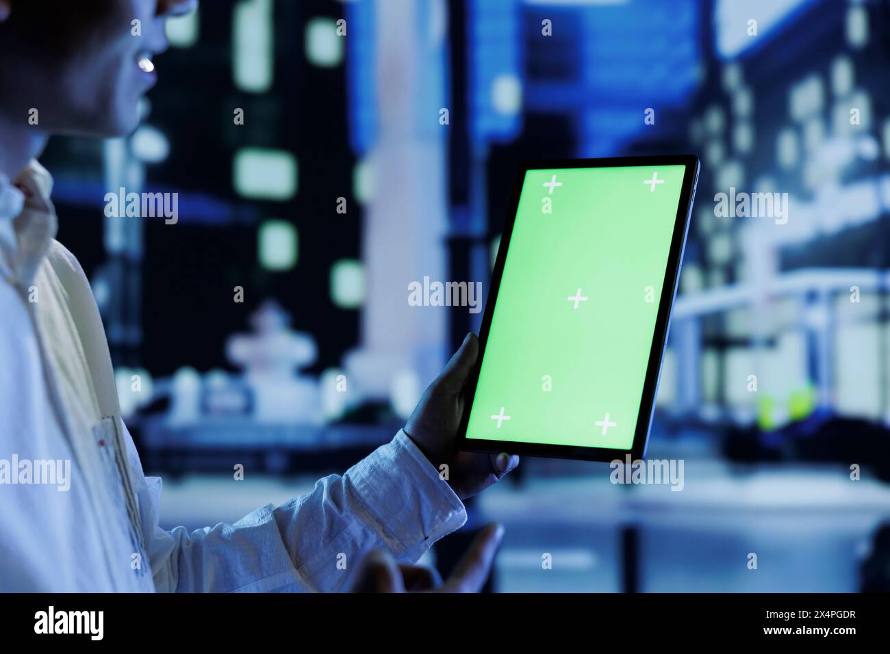 Man having fun walking around city at night, scrolling on online ...