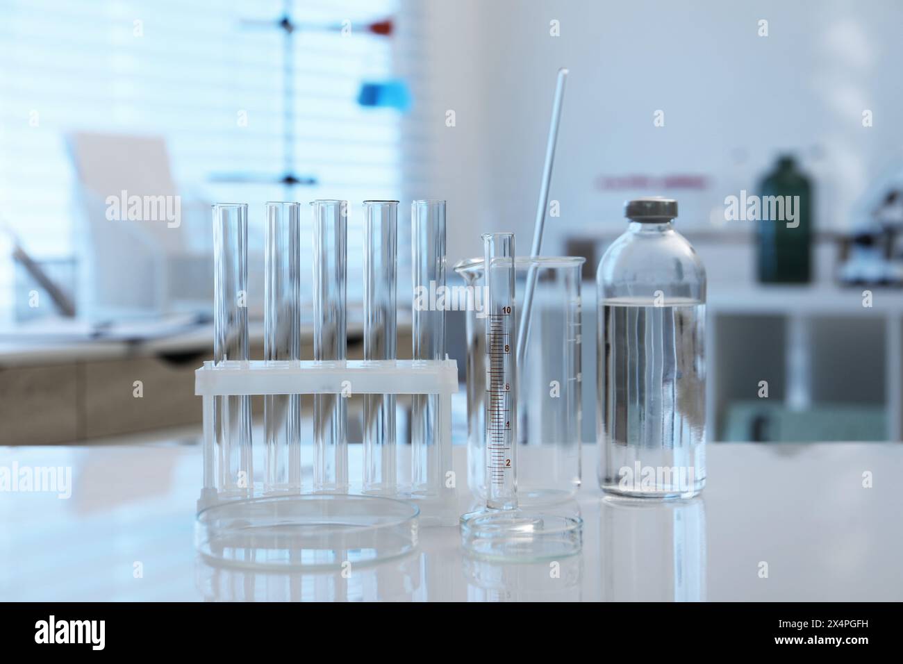 Laboratory analysis. Different glassware on white table indoors Stock ...