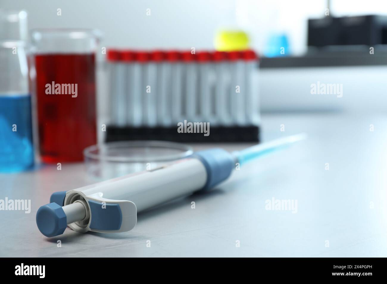 Laboratory analysis. Micropipette, beakers with liquids, petri dish and ...