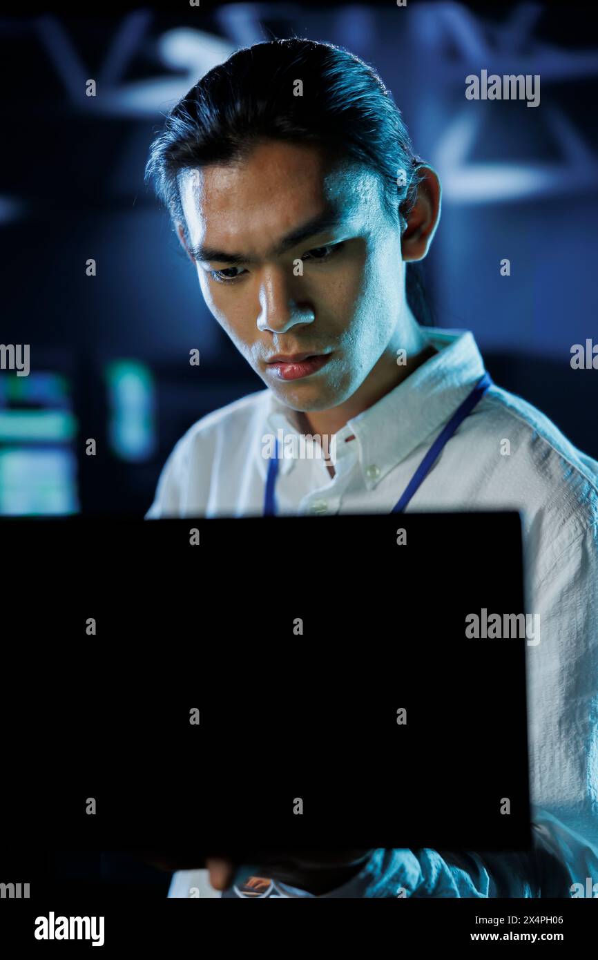 Dara center IT consultant running code and programming on laptop, troubleshooting and upgrading ...