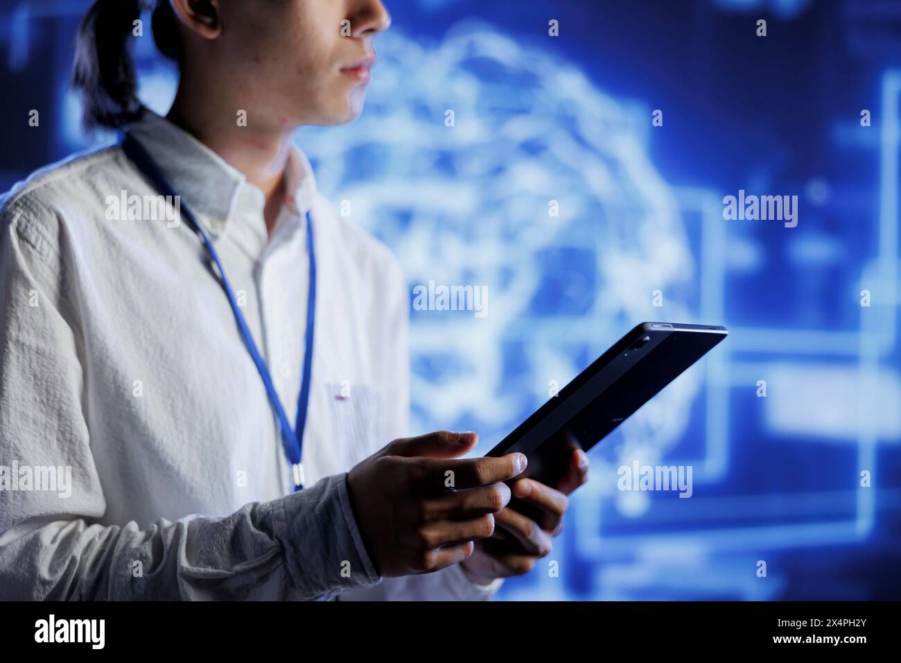 Admin using tablet in server farm to maintenance artificial ...