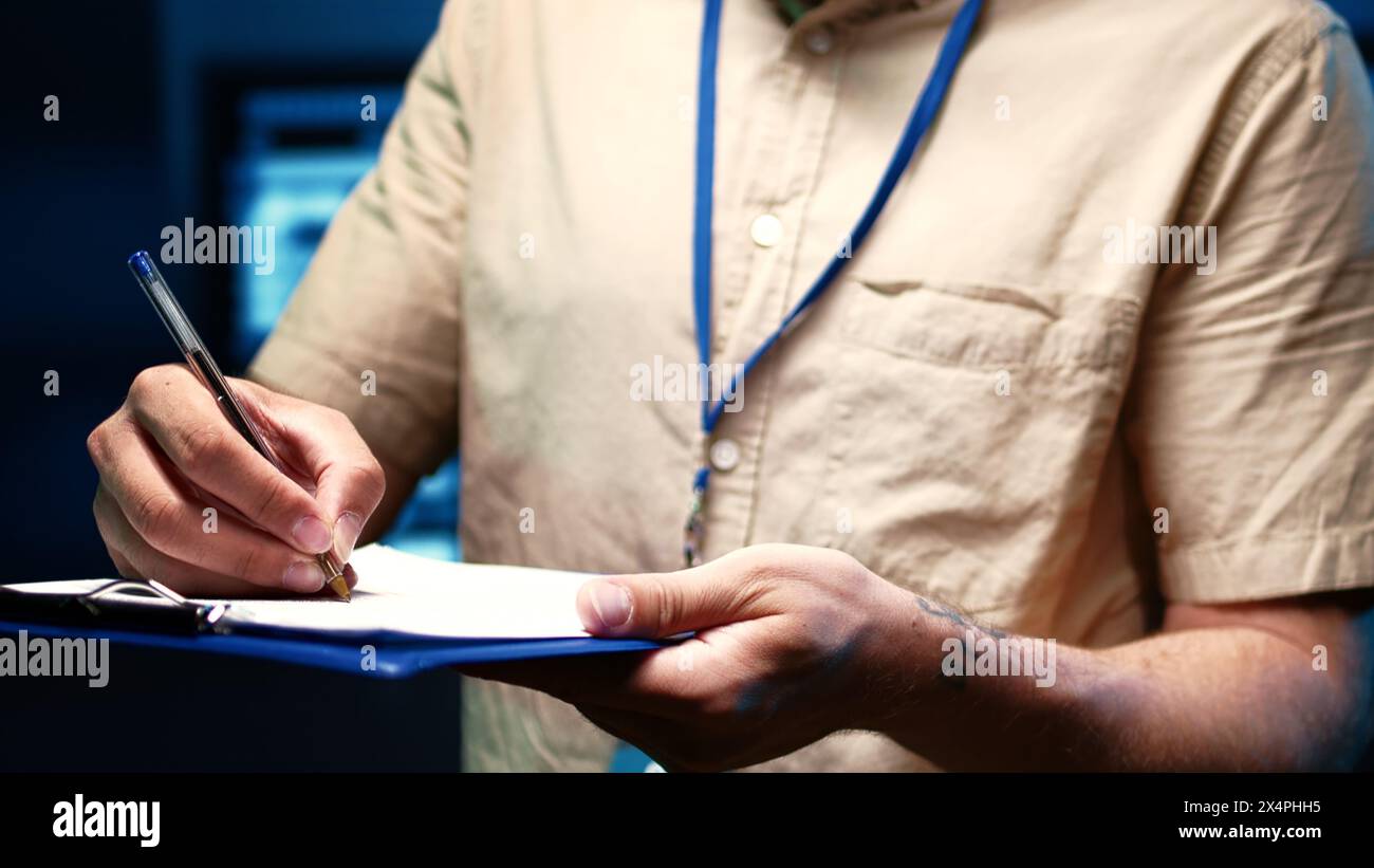 System admin doing maintenance writing hi-res stock photography and ...