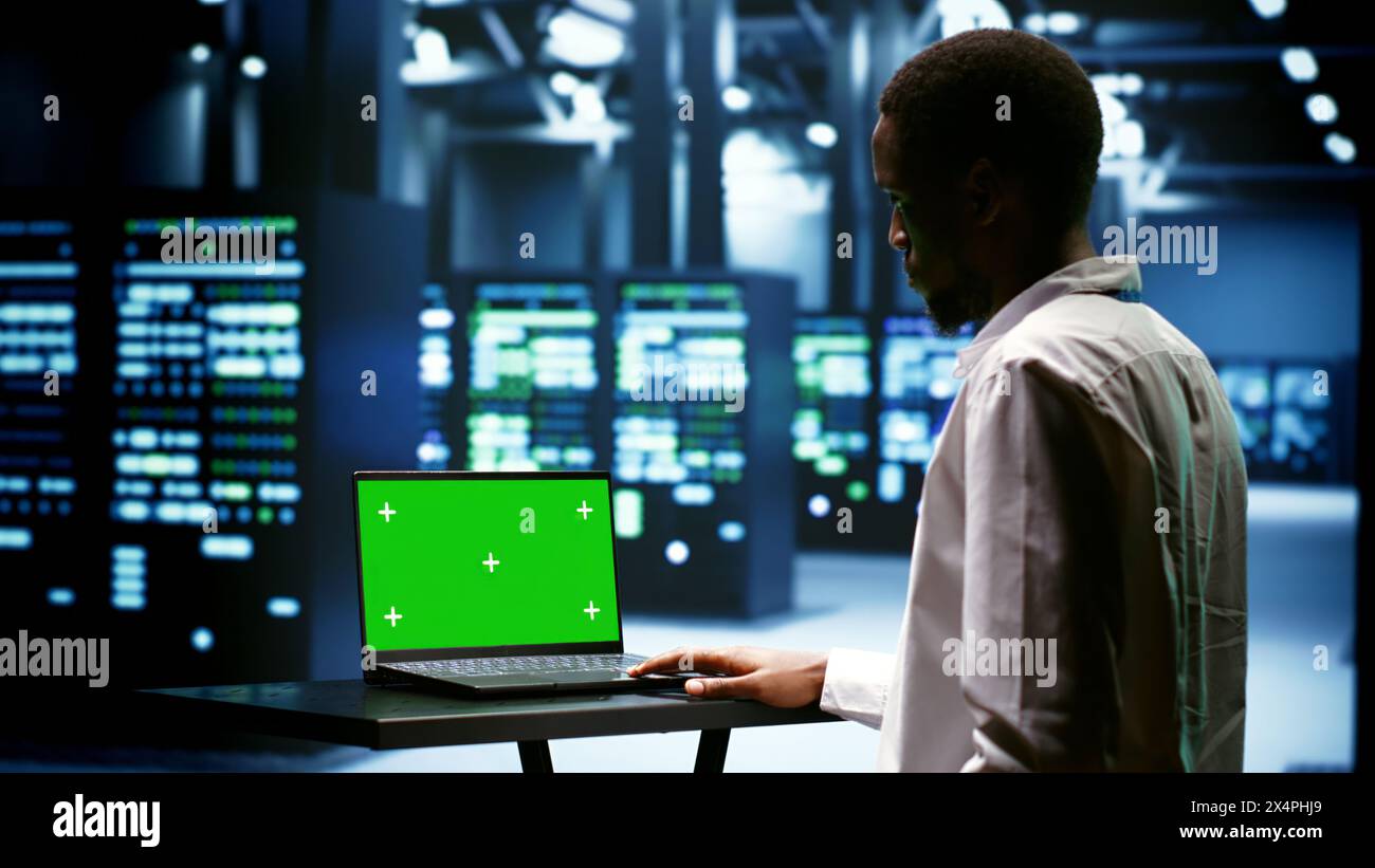 Supervisor Using Green Screen Laptop To Inspect Supercomputers Doing Intense Computations