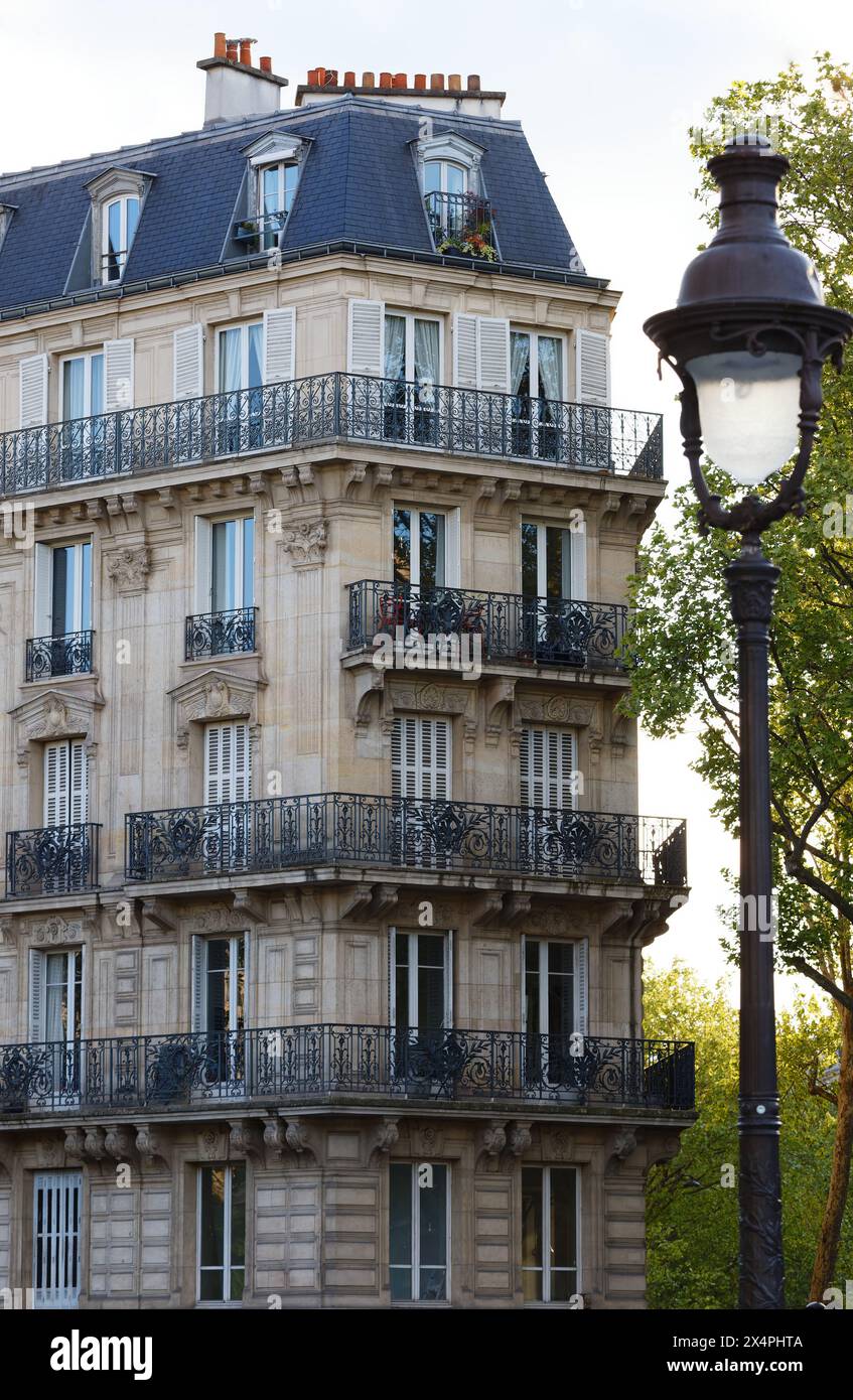 The facade of traditional French house with typical balconies and ...