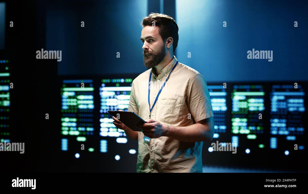 Worker doing yearly system reconditioning, imputing data on tablet of ...