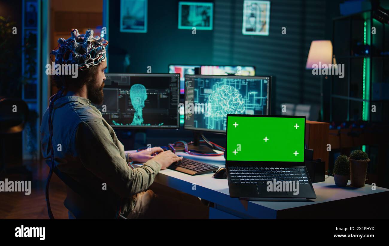 Engineer with EEG headset on programming brain transfer into computer ...
