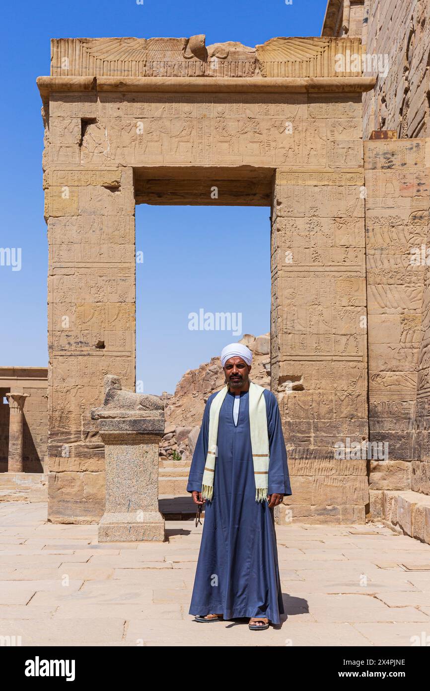 An Egyptian man in traditional attire inside the Temple of Isis at the ...