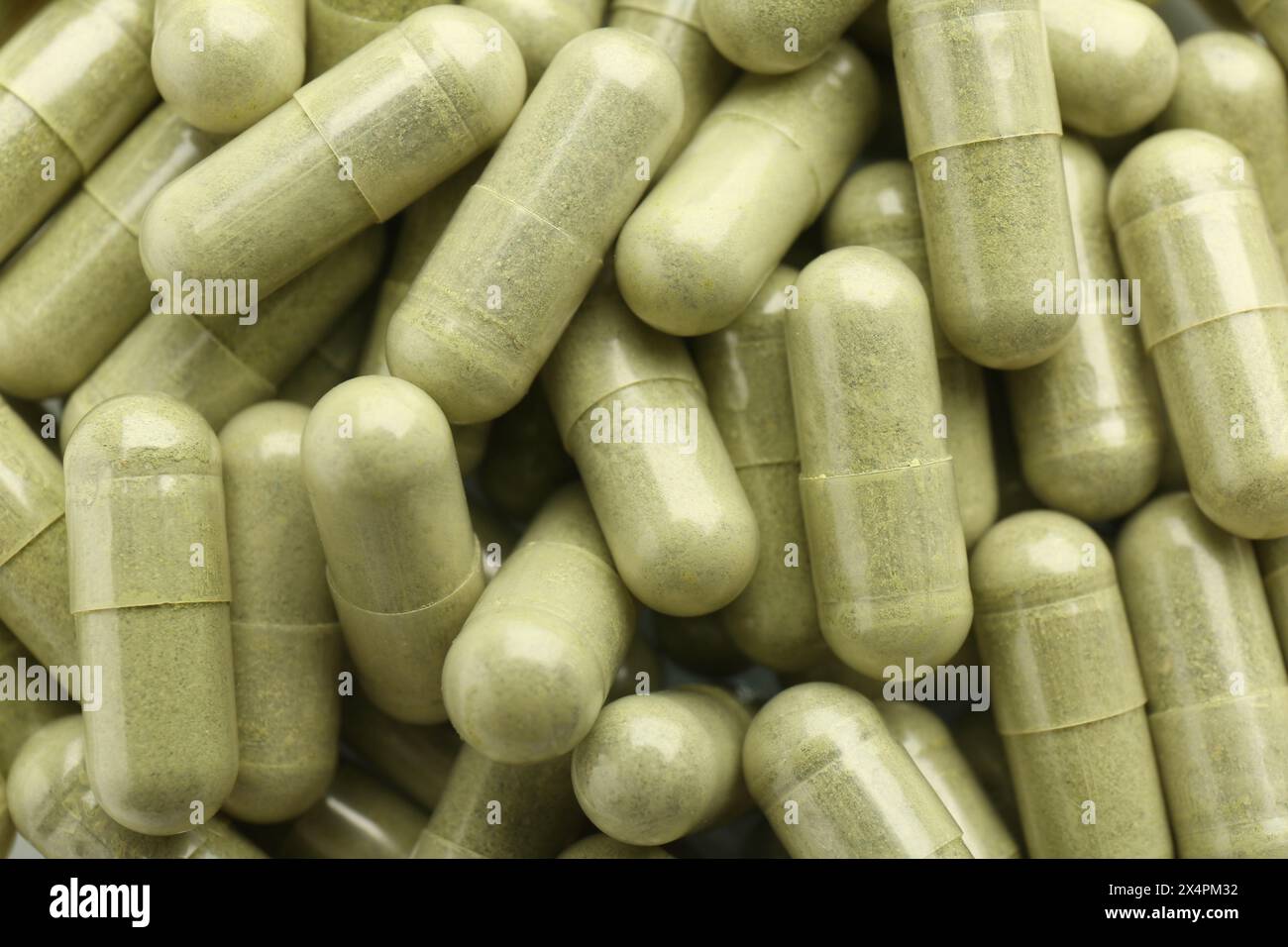 Light green vitamin capsules as background, top view Stock Photo - Alamy