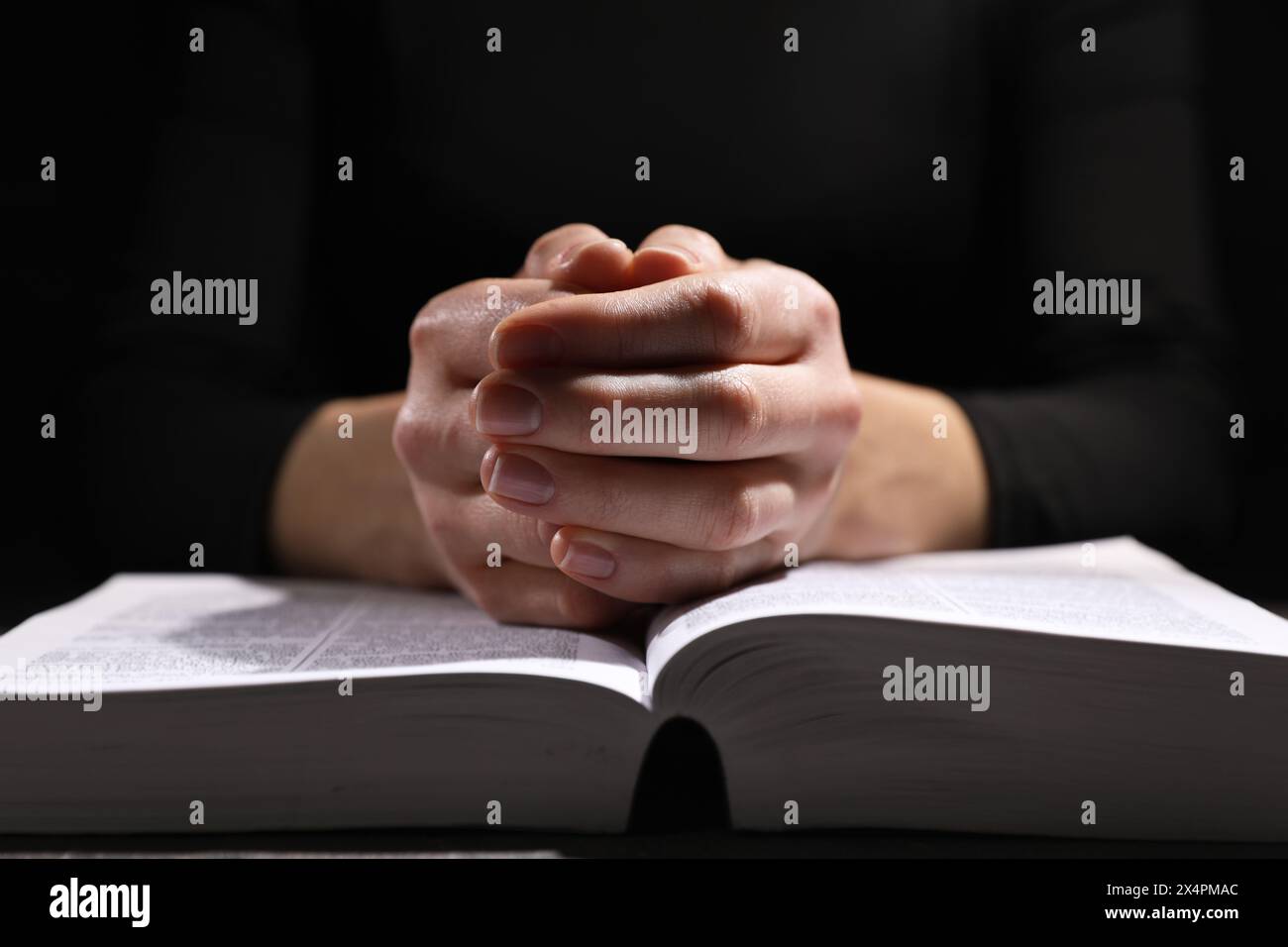 Religion. Christian woman praying over Bible at table, closeup Stock ...