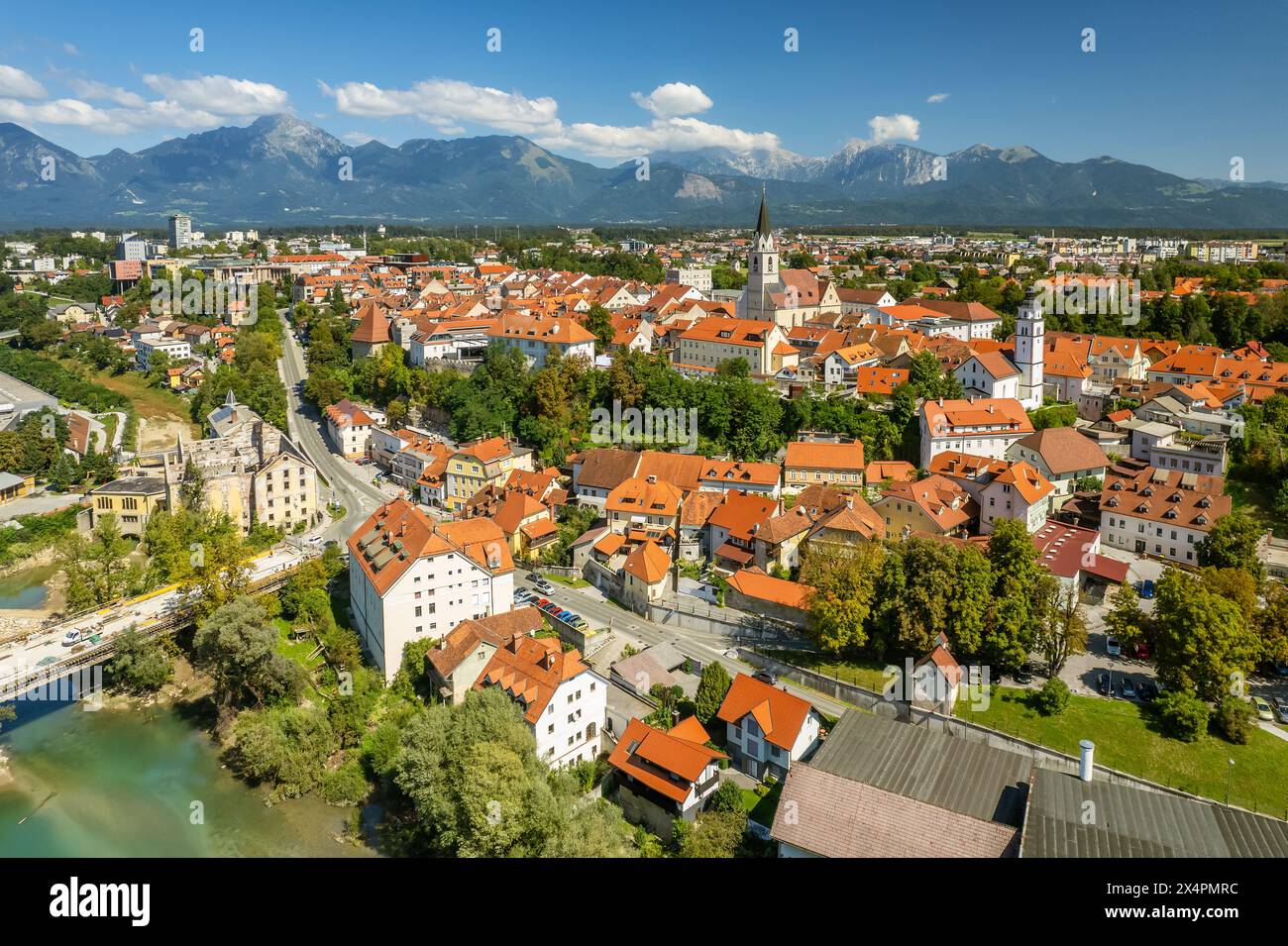Aerial view of the Kranj town with mountain range at background ...