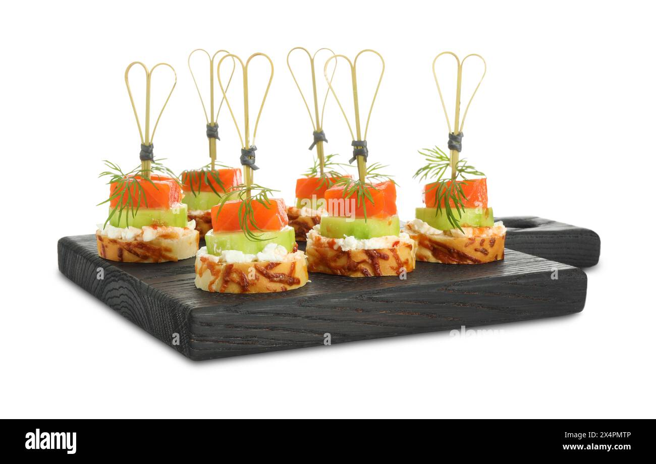Tasty canapes with salmon, cucumber, bread and cream cheese isolated on ...