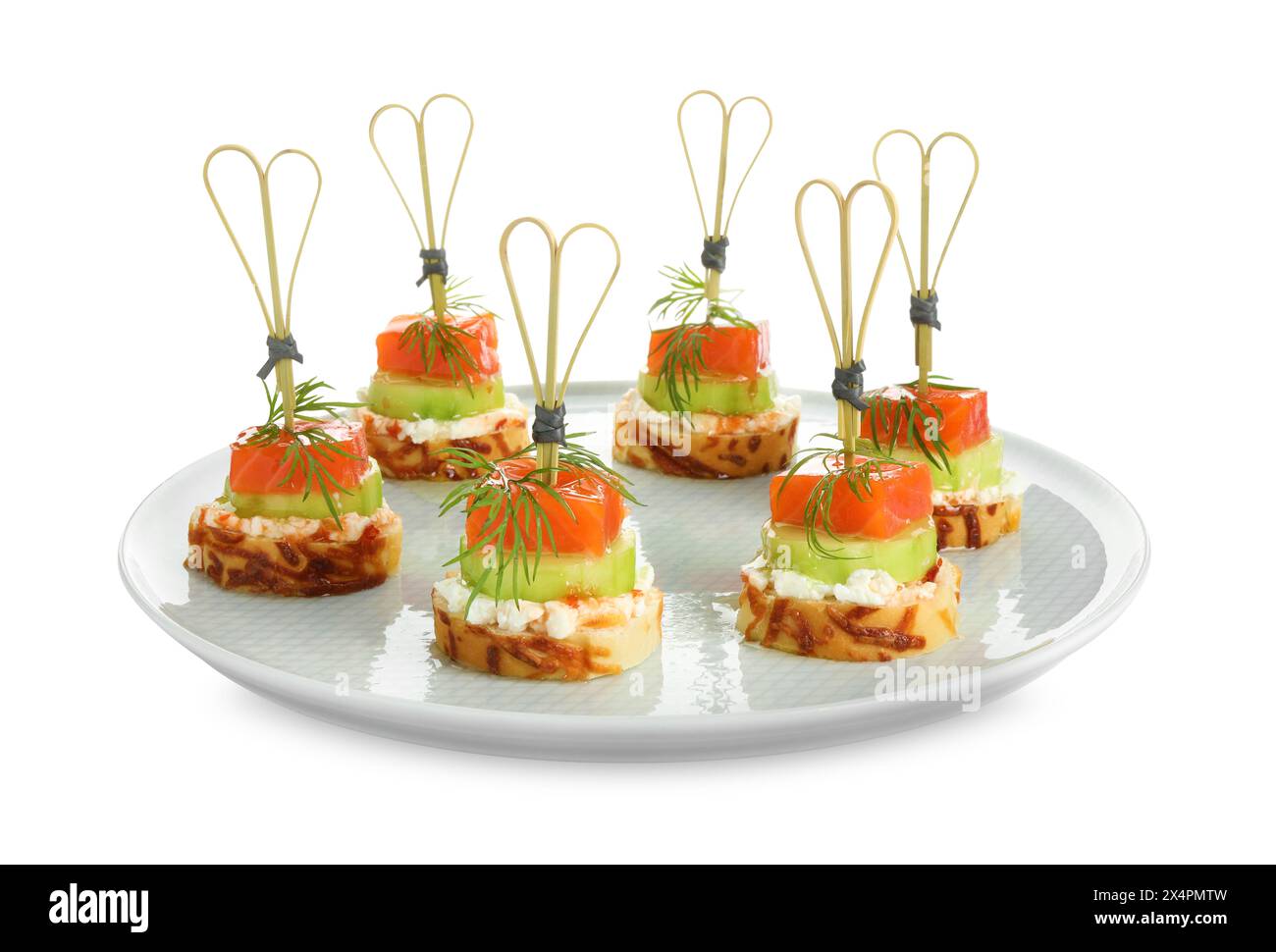 Tasty canapes with salmon, cucumber, bread and cream cheese isolated on ...