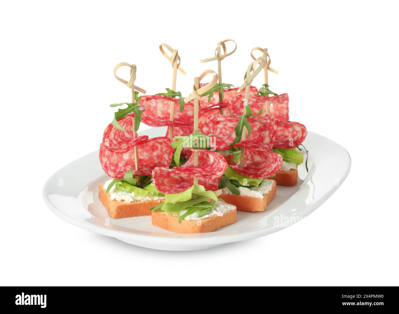 Tasty canapes with salami, greens and cream cheese isolated on white ...