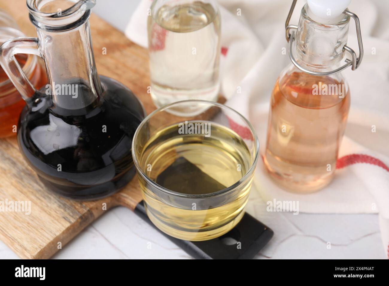 Different types of vinegar on white table Stock Photo - Alamy