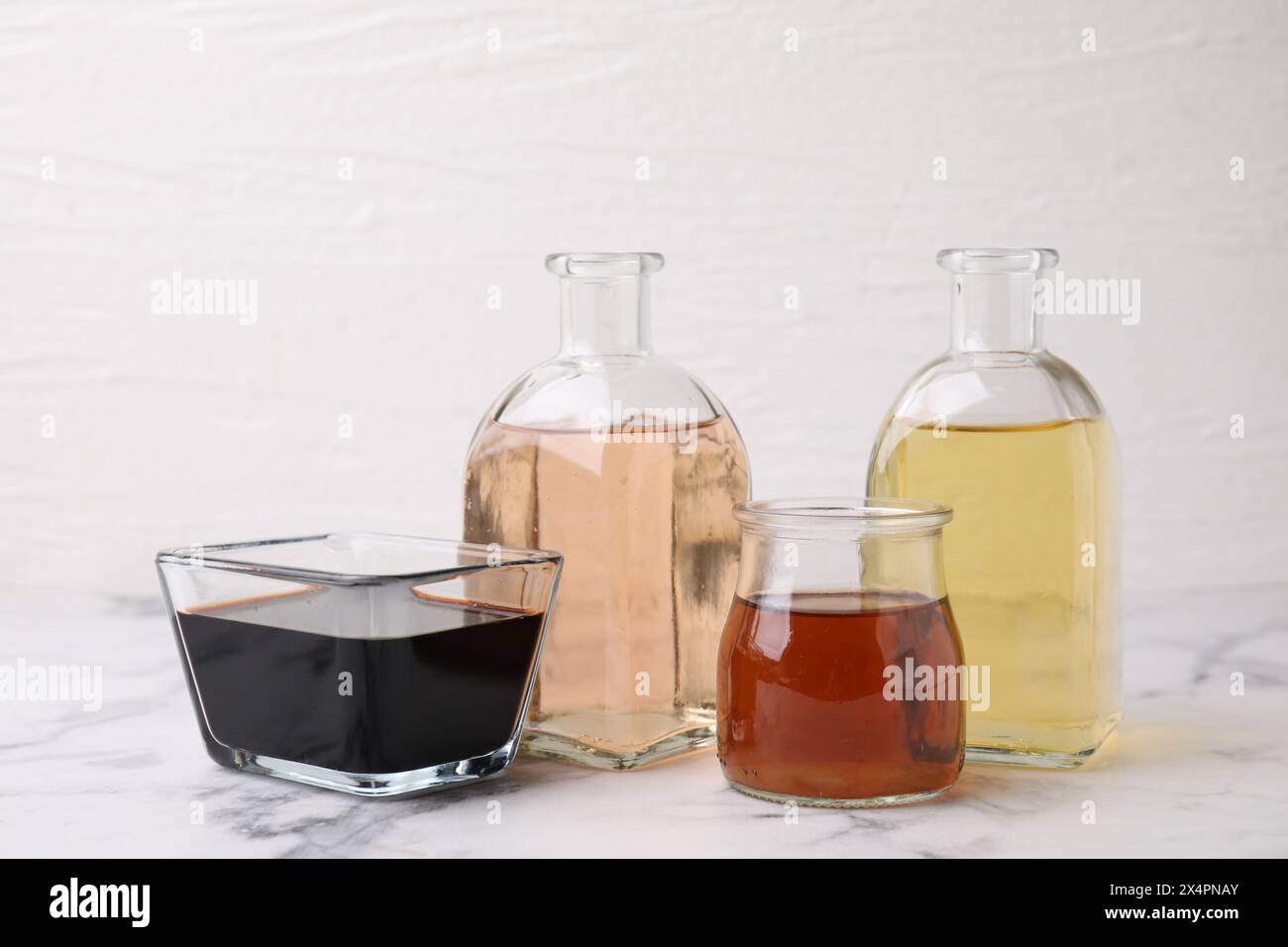 Different types of vinegar on light marble table, closeup Stock Photo ...