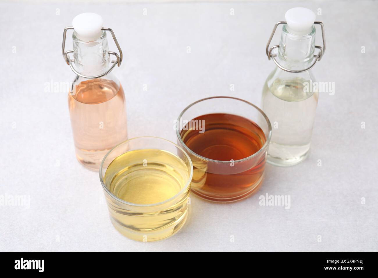Different types of vinegar on light table, closeup Stock Photo - Alamy