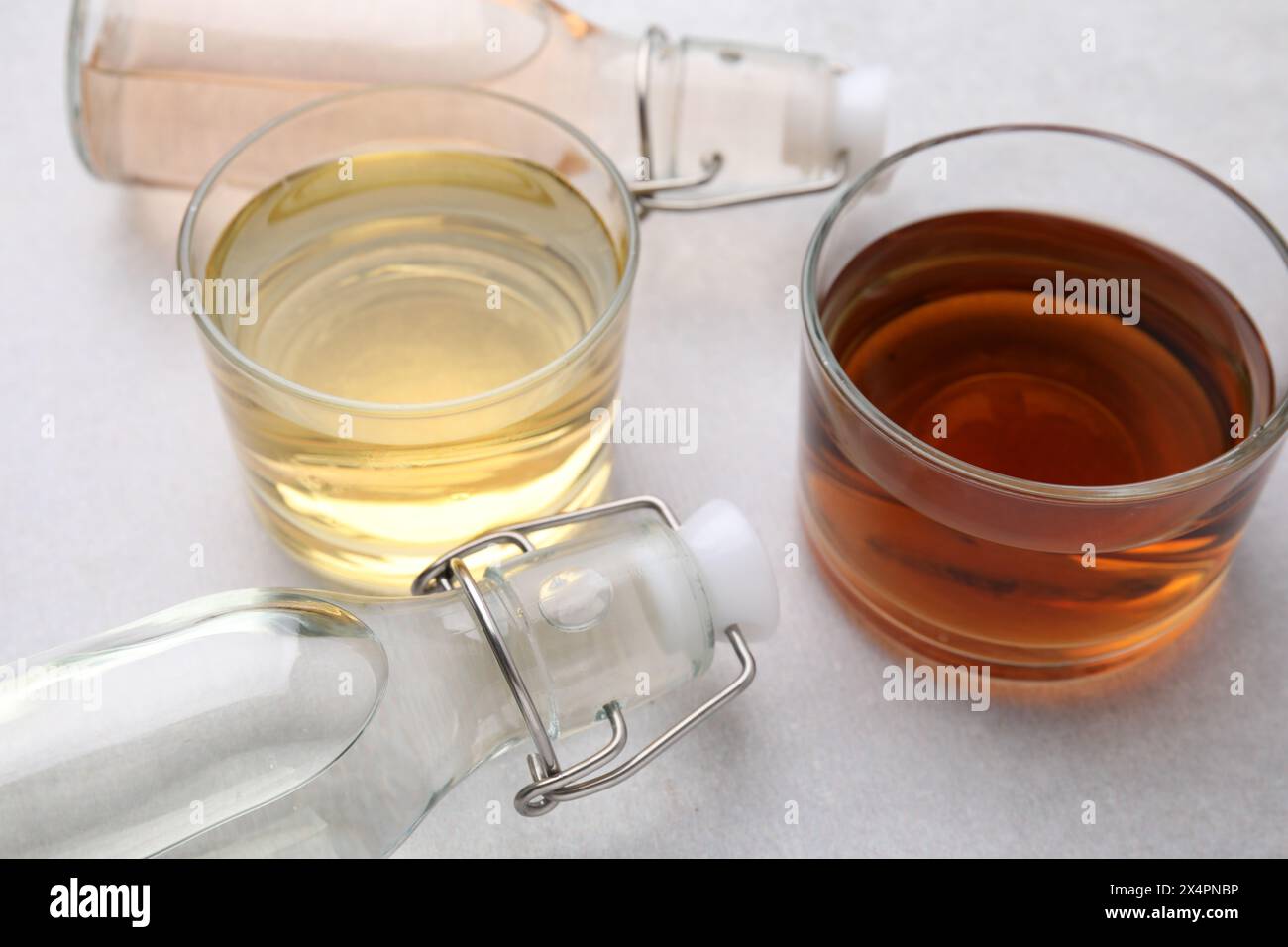 Different types of vinegar on light table, closeup Stock Photo - Alamy