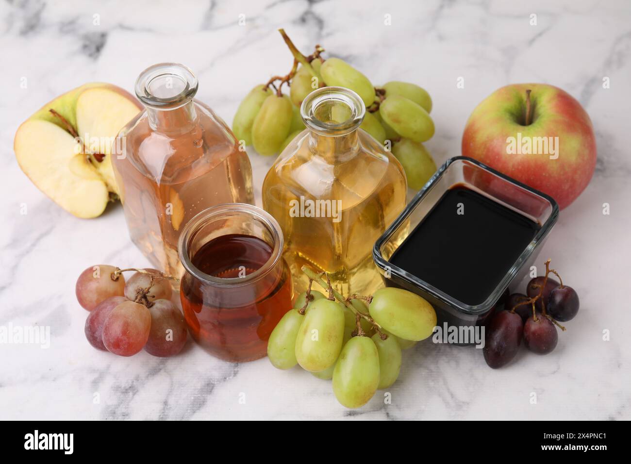 Different types of vinegar and ingredients on light marble table ...