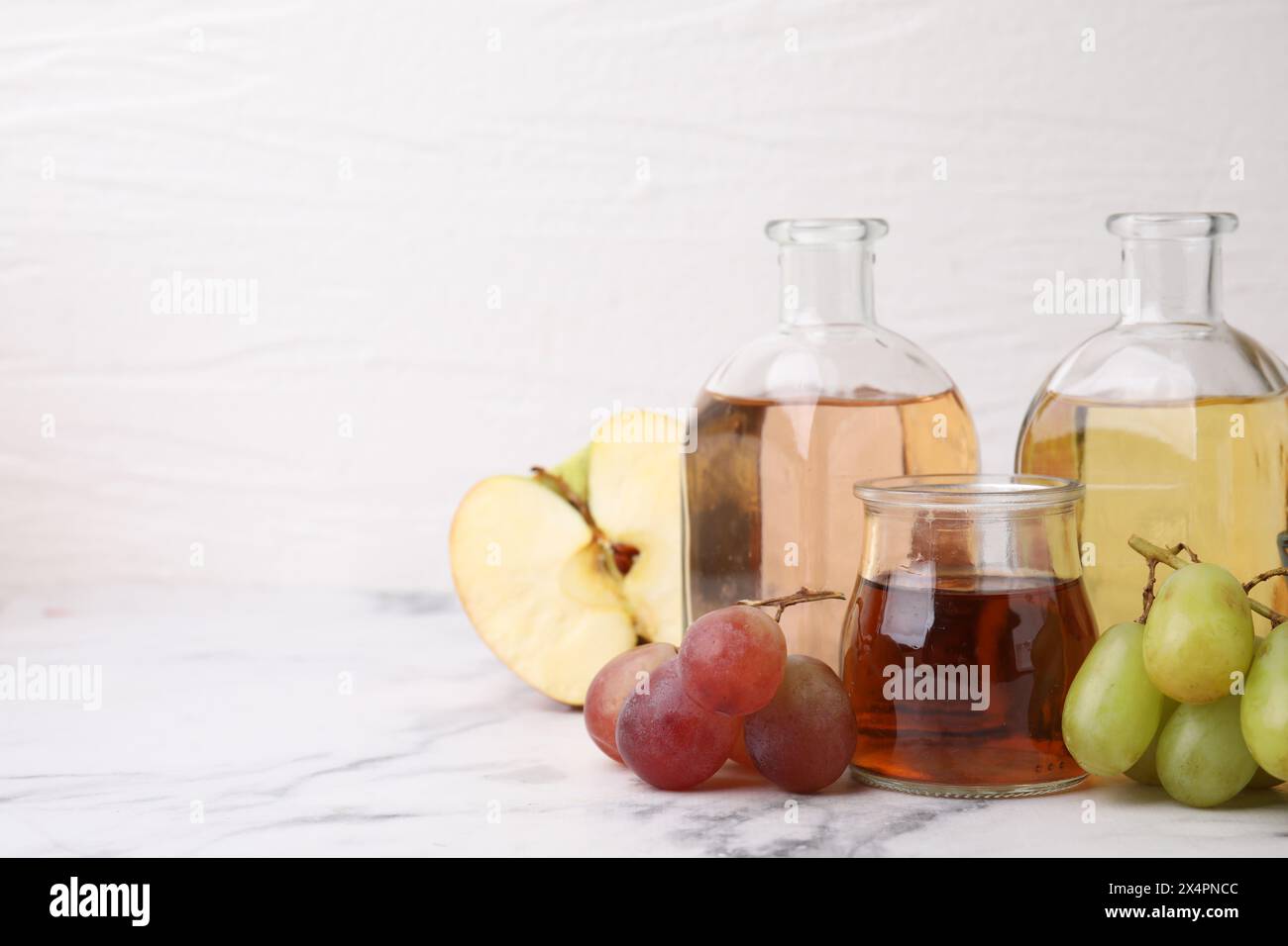 Different types of vinegar and ingredients on light marble table ...