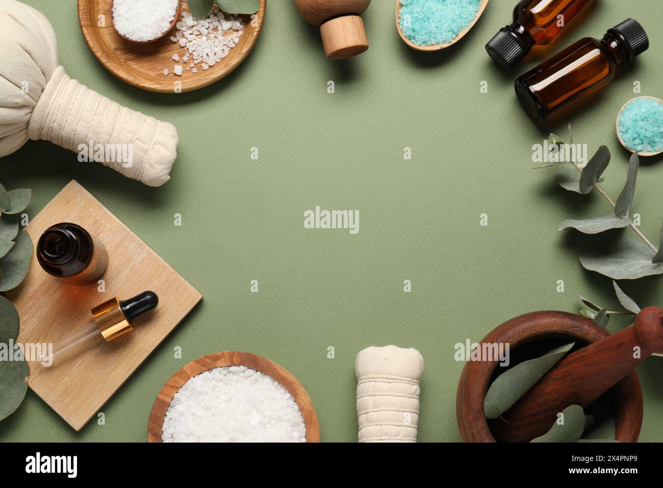 Different aromatherapy products and eucalyptus leaves on olive ...