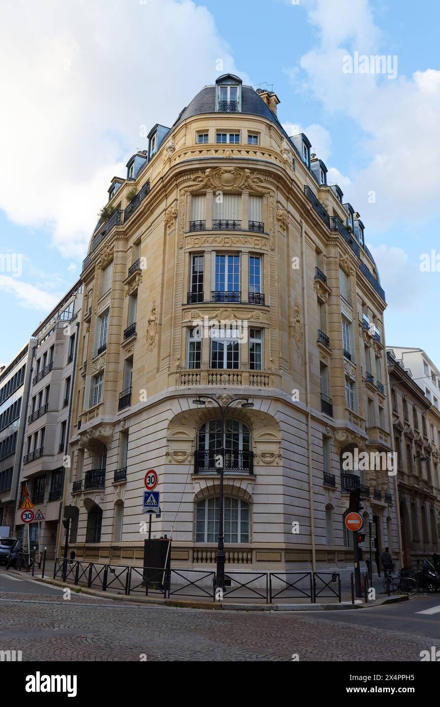 The facade of traditional French house with typical balconies and ...