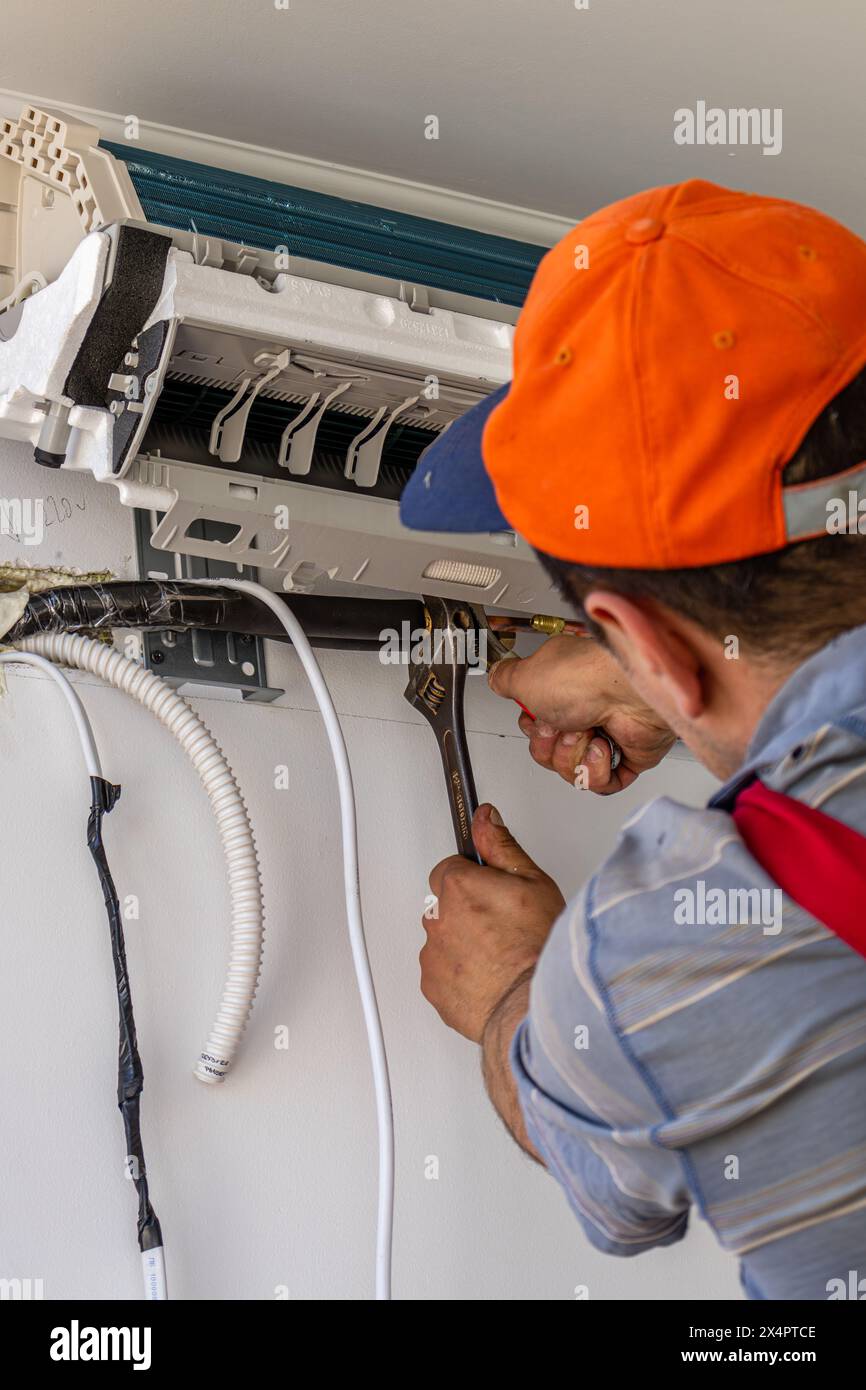 Repairman team installing air conditioner Lviv Ukraine 08.04.24 Stock ...