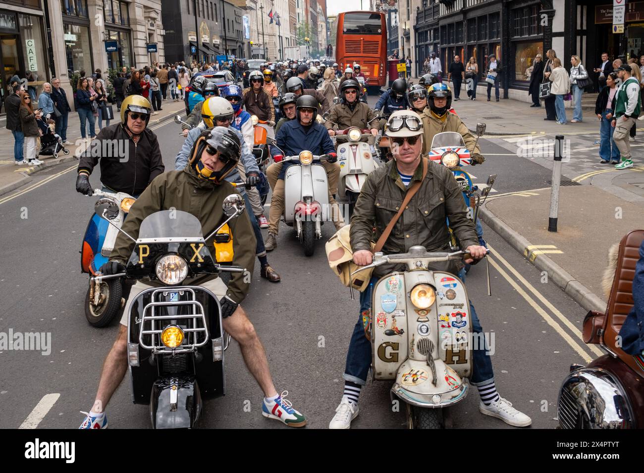 Classic Scooter riders line up on a London Street. Scooter owners ...