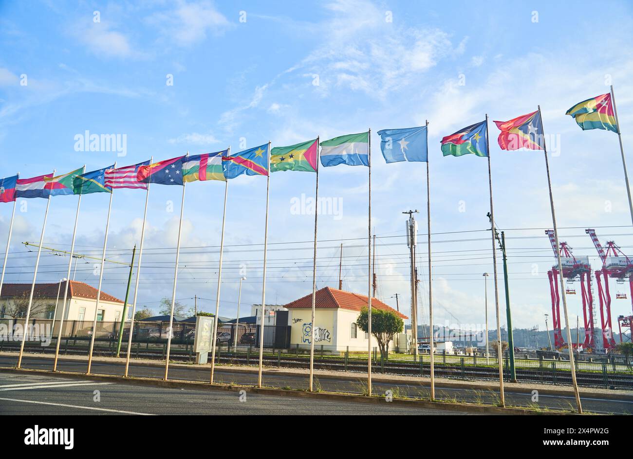 Colorful flags flutter in the sky above urban buildings Stock Photo - Alamy
