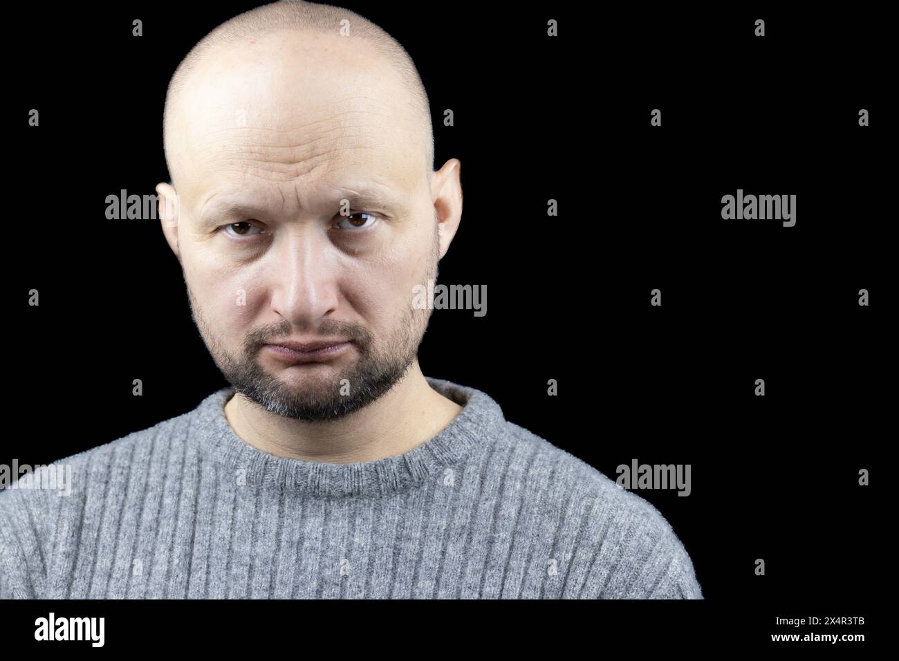 This is a compelling portrait of a man, set against a stark black ...