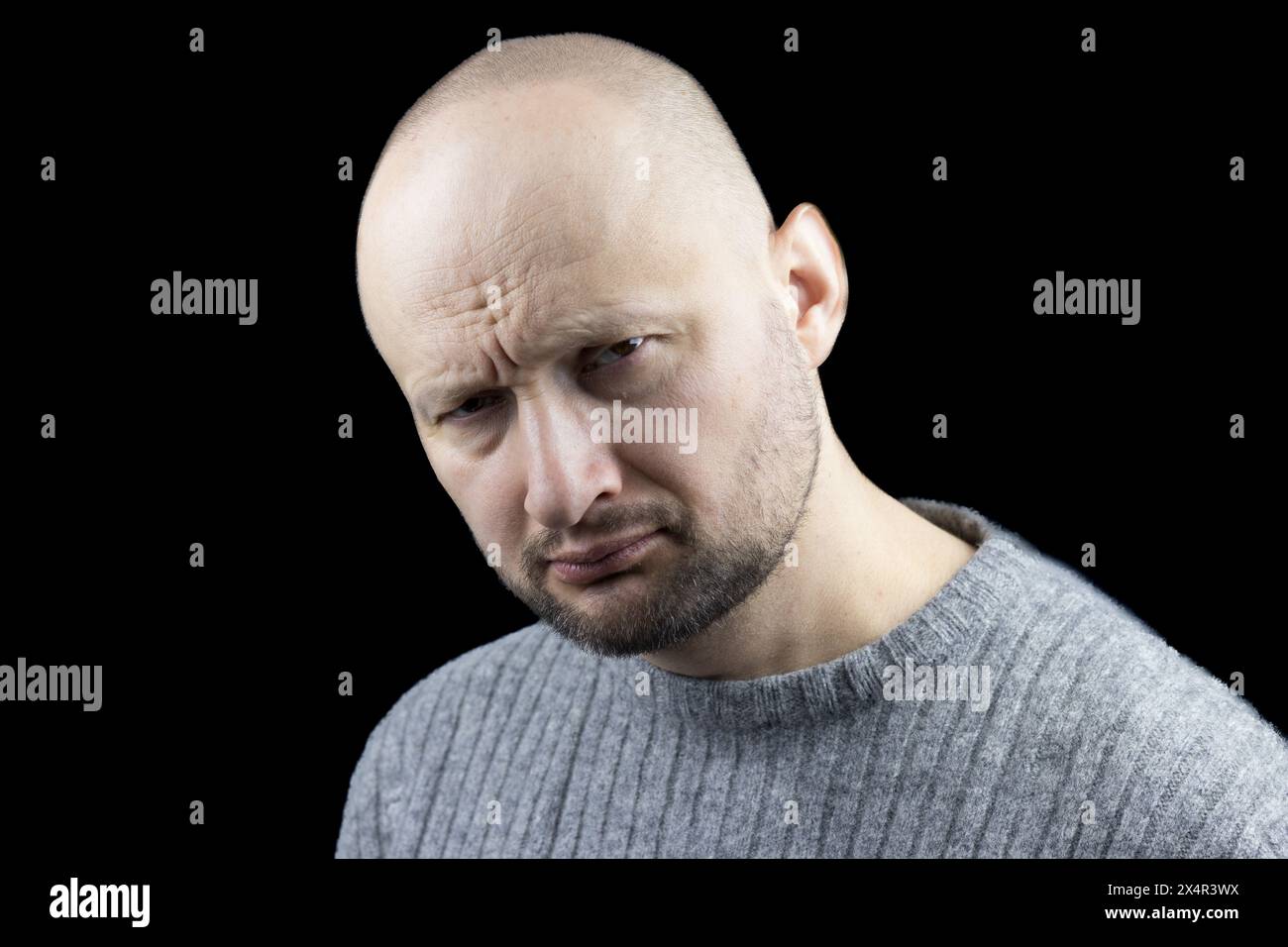 This is a powerful portrait of a man, set against a stark black ...