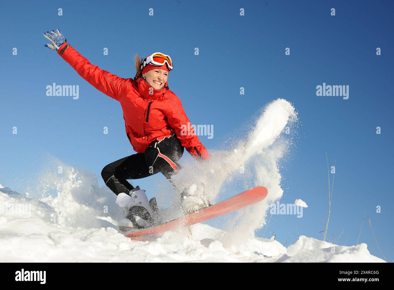 pretty young woman on snowboard Stock Photo - Alamy