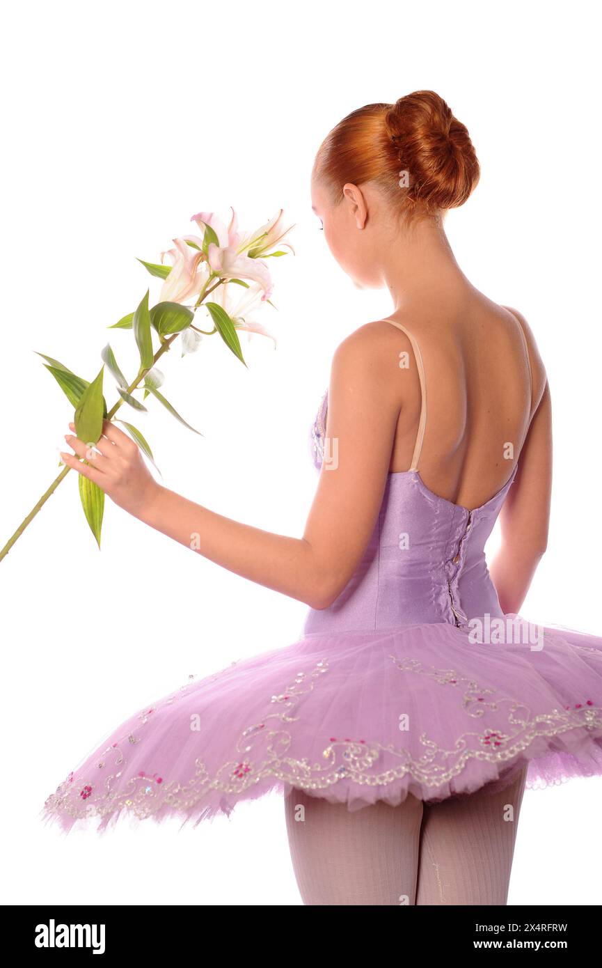 back of calm red-haired ballet dancer with lily isolated on white Stock ...