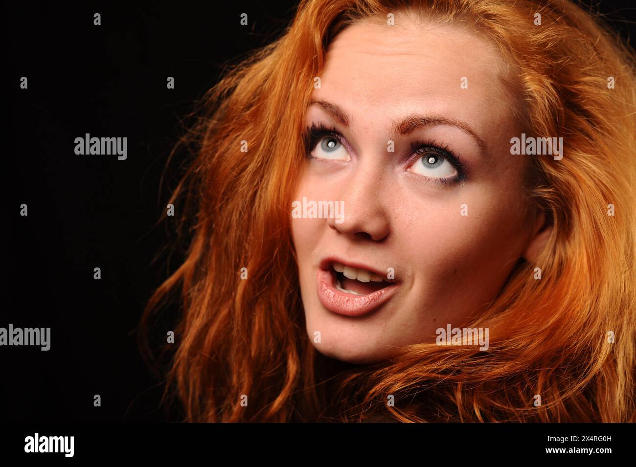 portrait of beauty girl with ginger curly hairs and strange emotion ...