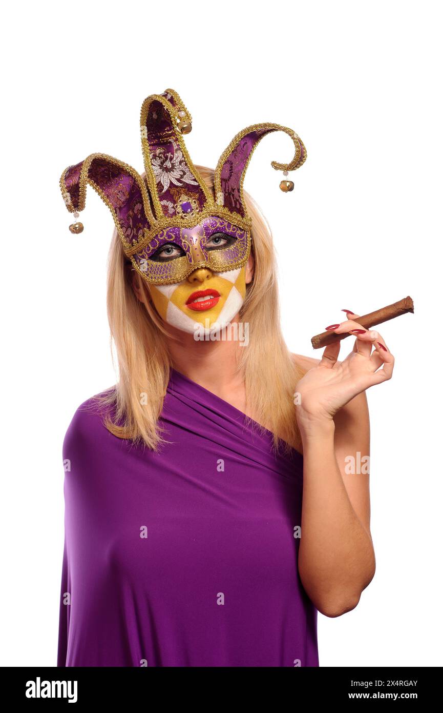 Woman in carnival venetian mask posing with cigar isolated on white ...