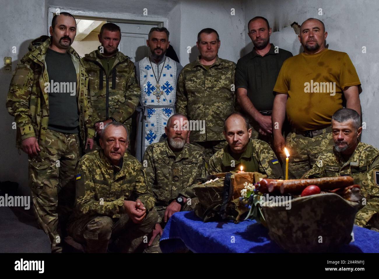 A chaplain and servicemen of Ukraine's 141st separate infantry brigade ...