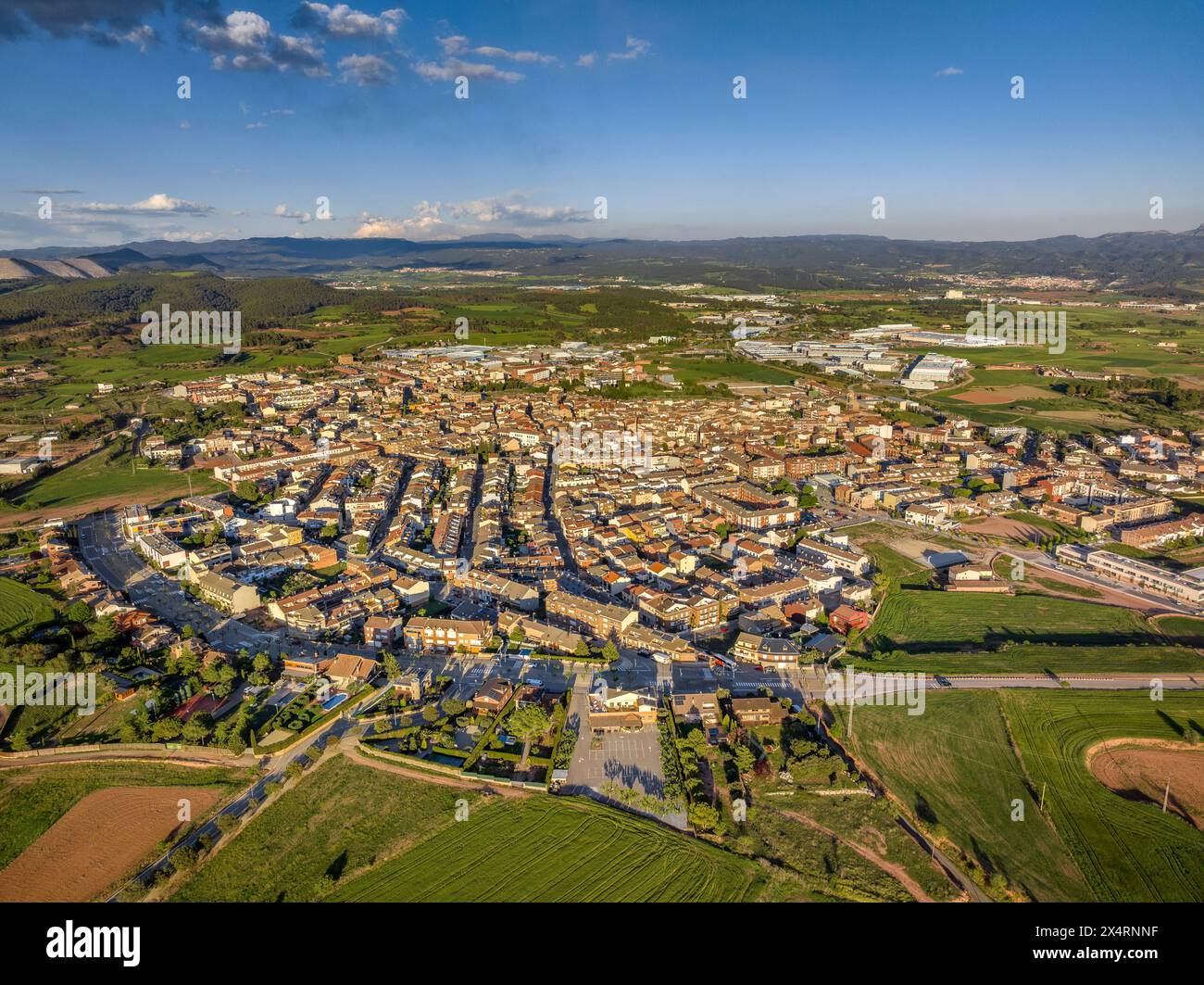 Aerial view of the town of Santpedor and the green fields of Pla de ...