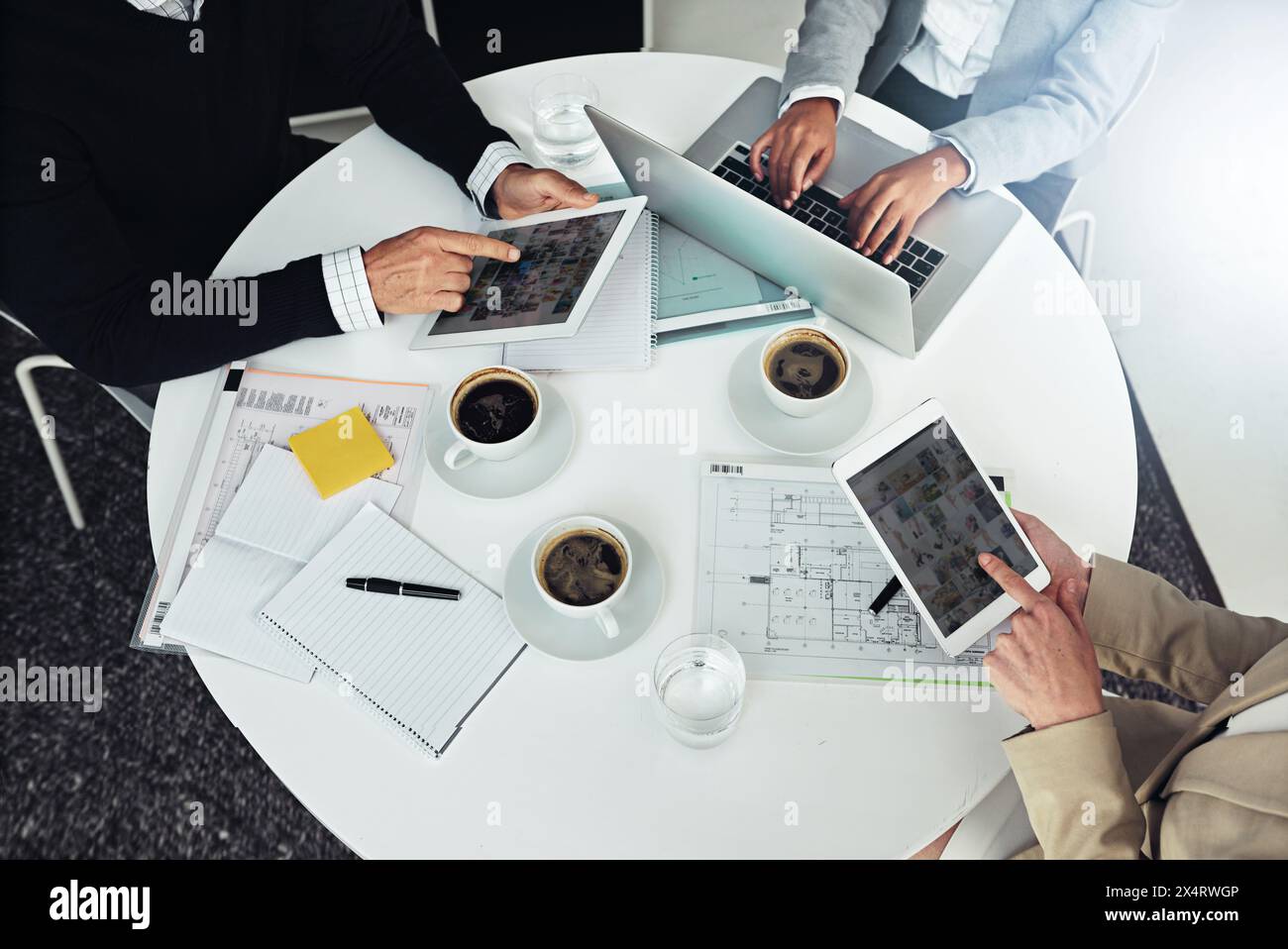 Teamwork, tablet and hands with coffee in workplace for morning ...