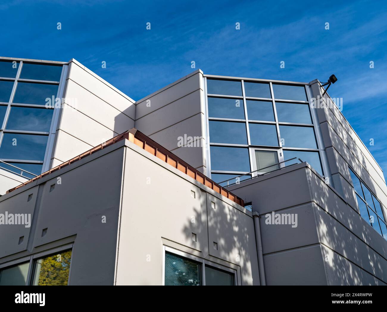 The upper windows and roof patio of a modern office building Stock ...