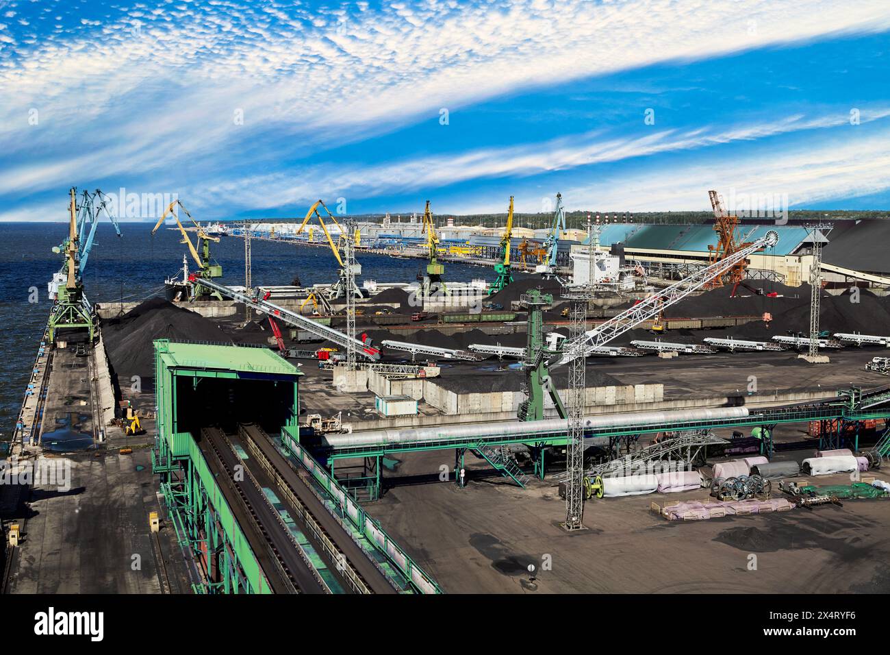Automatic conveyor belt in coal harbor, bulk carrier stands near pier ...