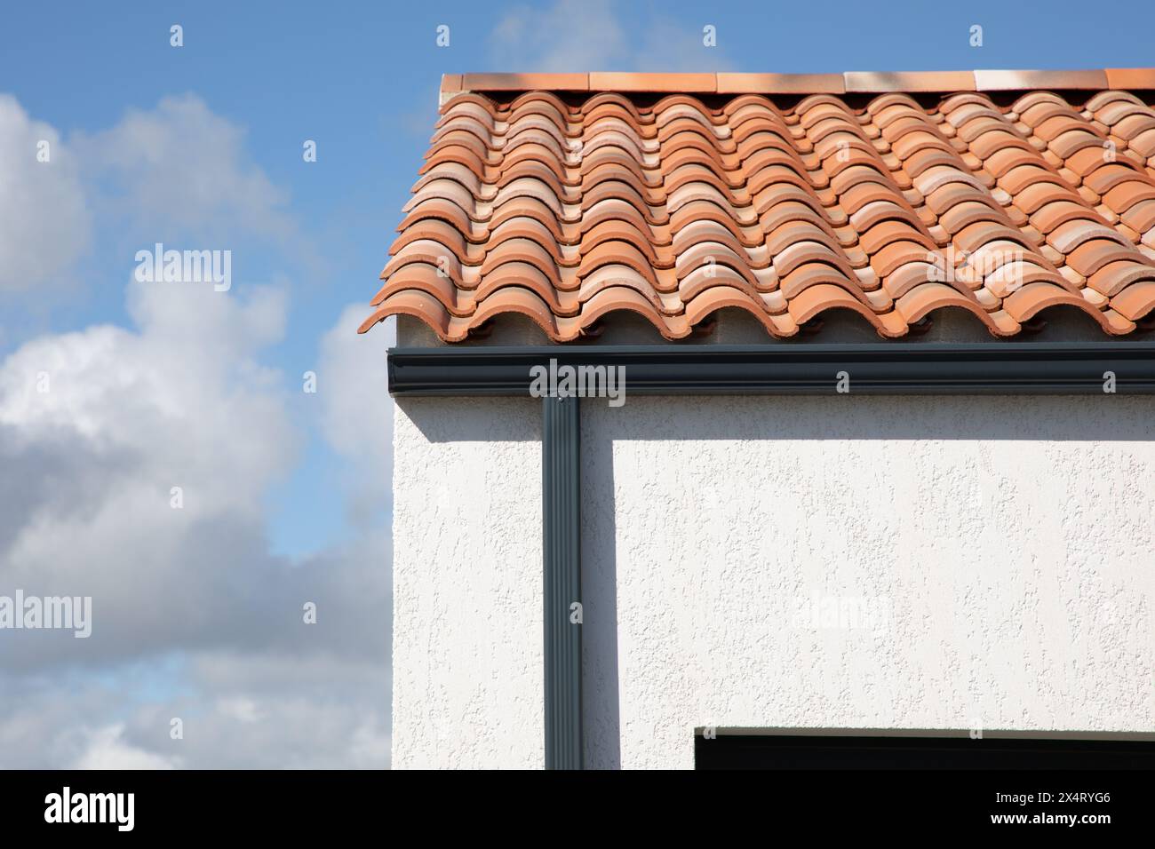 aluminum grey gutter on modern roof of the building and gray downpipe ...