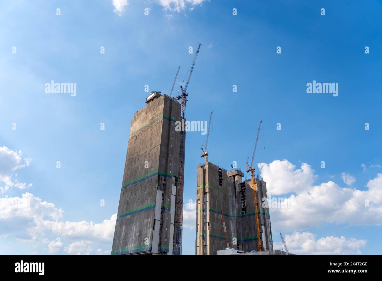 Couple standing high-rise towers in the scaffolding are covered with ...