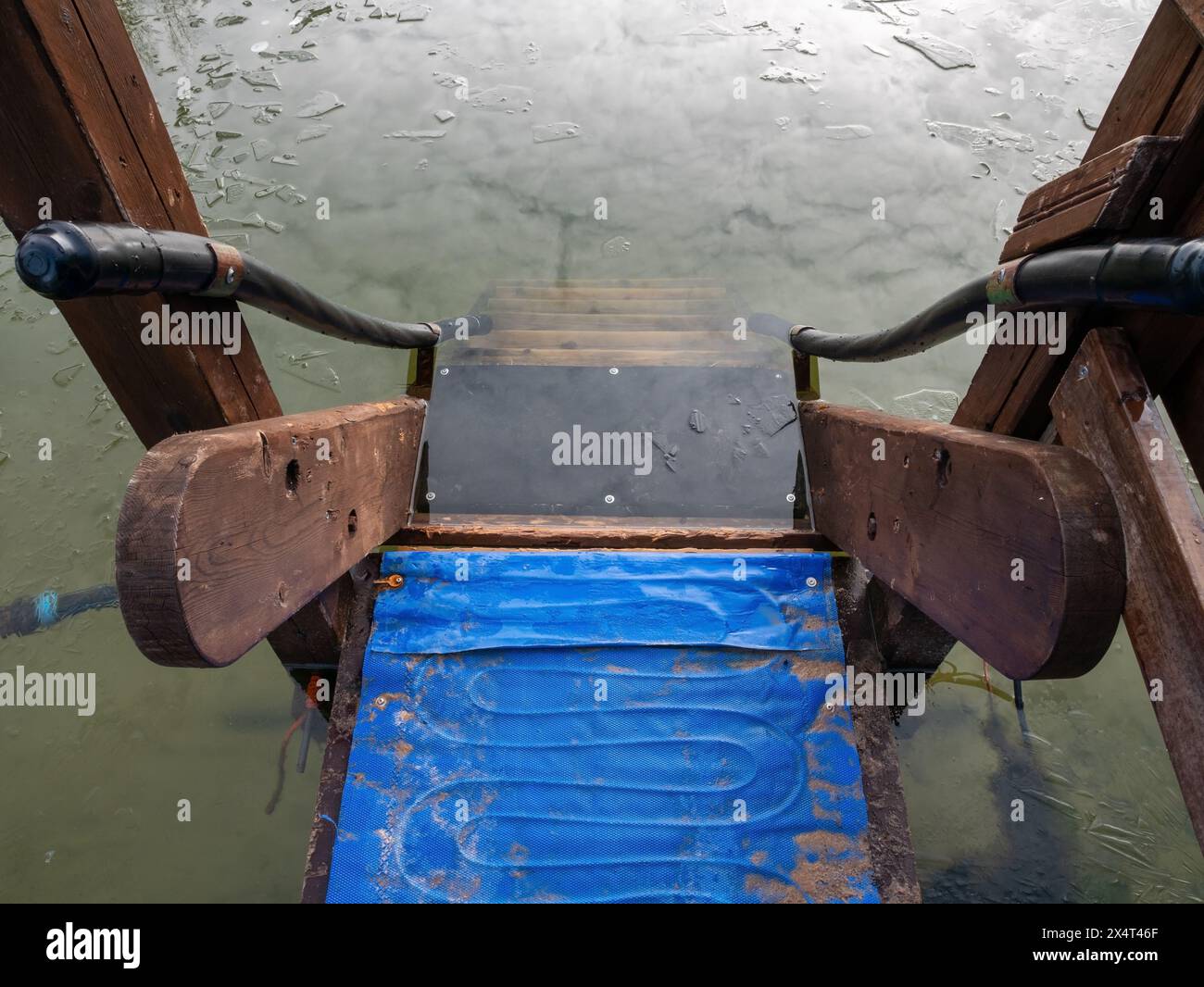 Swimming pool hand-rails and ladder leading into freezing pond, Finland ...