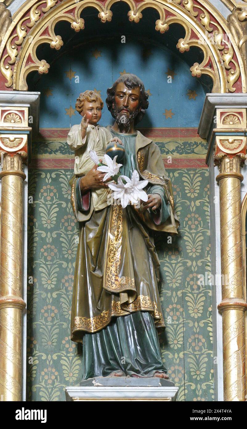 Saint Joseph holding the child Jesus, statue on the altar of Saint Joseph in the parish church ...