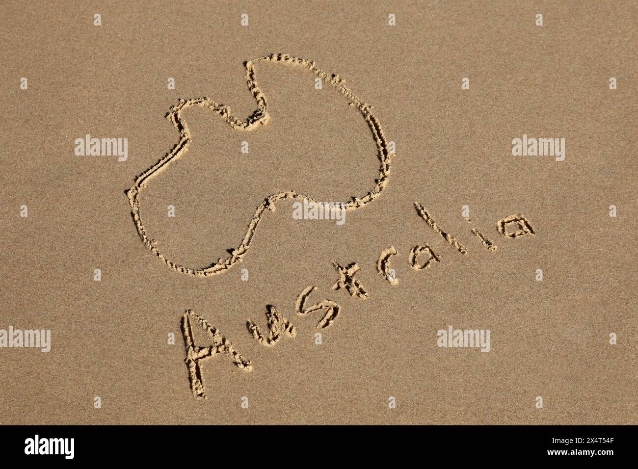 Australia written in the sand at the beach with Australian map shape ...