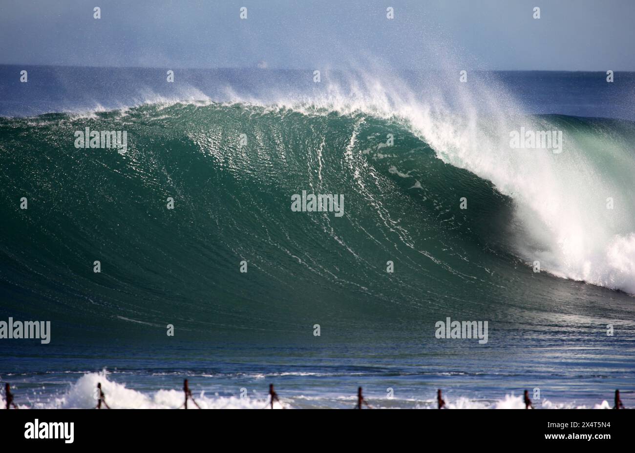 A giant wave breaks towards the shore at Newcastle Beach Australia ...