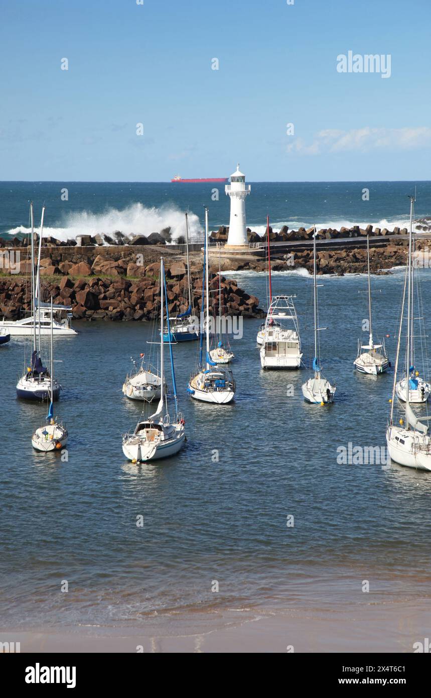 Wollongong Harbour and lighthouse during rough seas. Wollongong is a ...