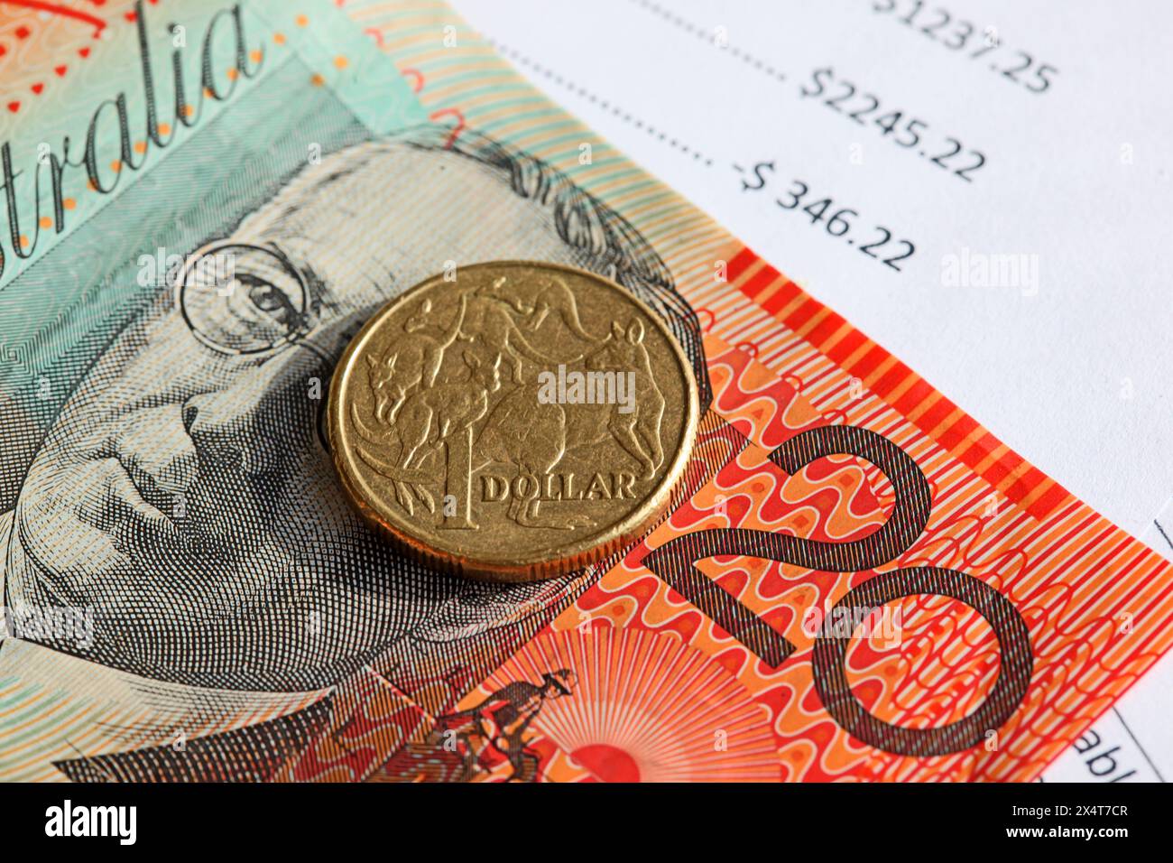 Australian twenty dollar note with one dollar coin with financial ...