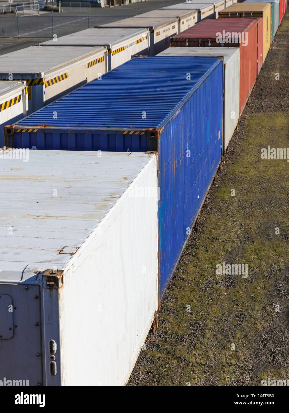A freight train loaded with containers transporting goods across the ...